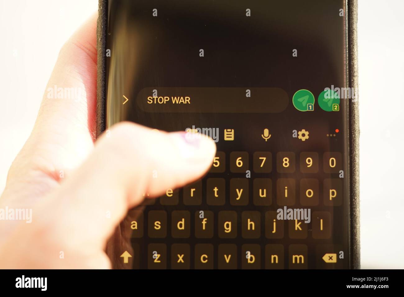 Female hand typing on a black smartphone a message STOP WAR Stock Photo ...