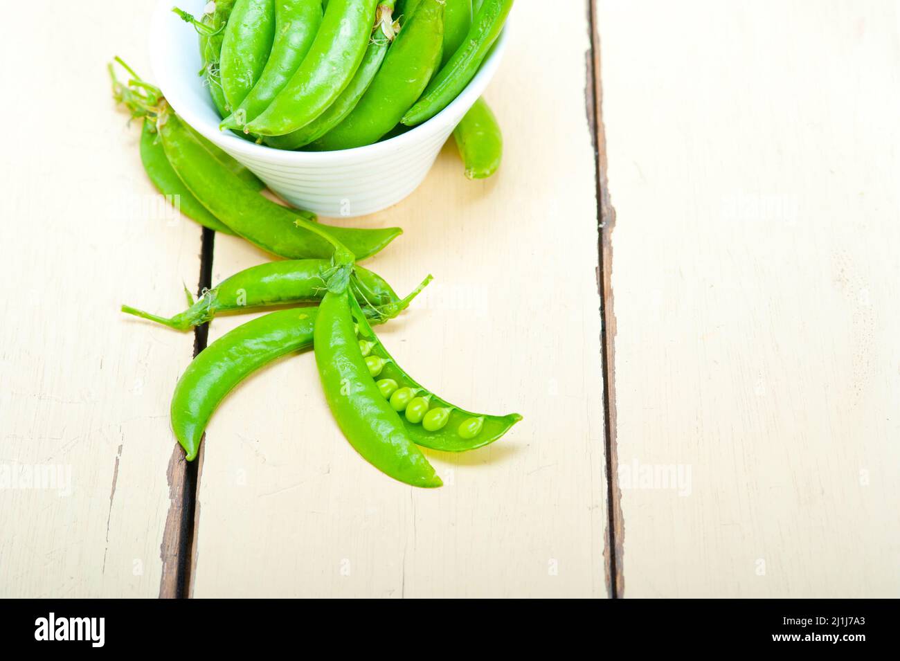 hearthy fresh green peas over a rustic wood table Stock Photo - Alamy