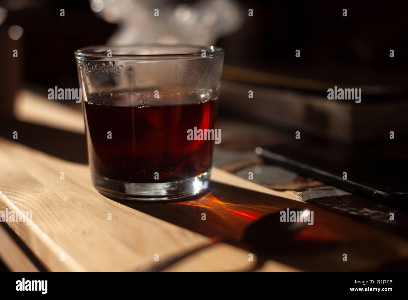 Tea in glass. Kitchen details. Hot drink in morning. Strong black tea ...