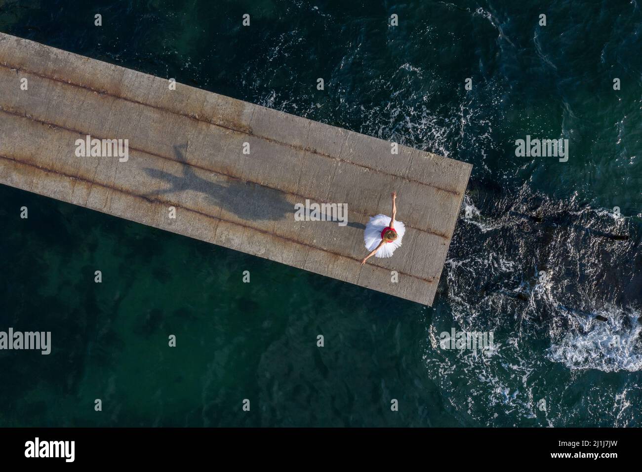 Aerial view at female ballet dancer on sunny sea pier Stock Photo - Alamy