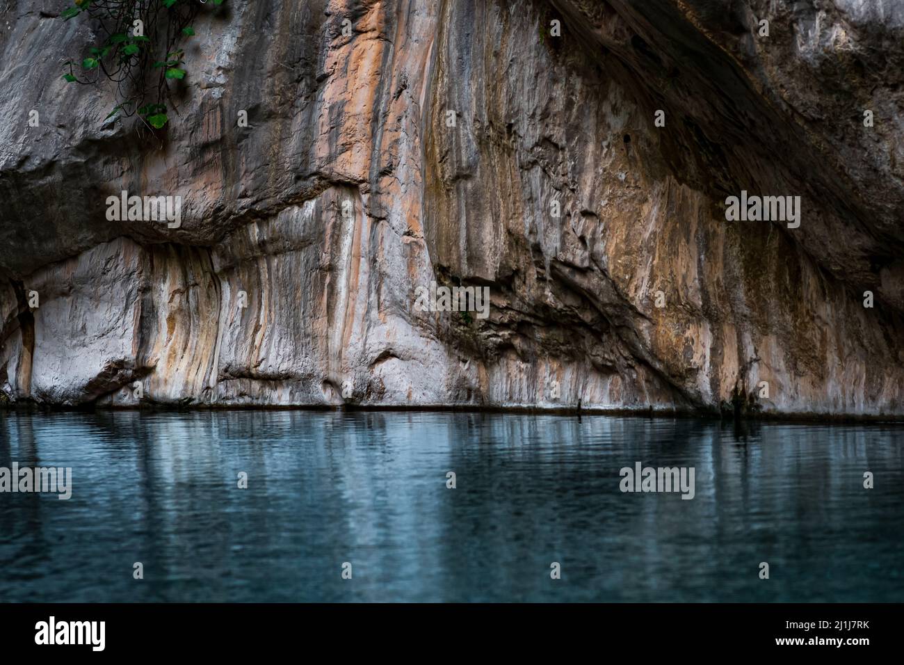 clean blue stream with rocky banks at the bottom of a deep canyon Stock ...