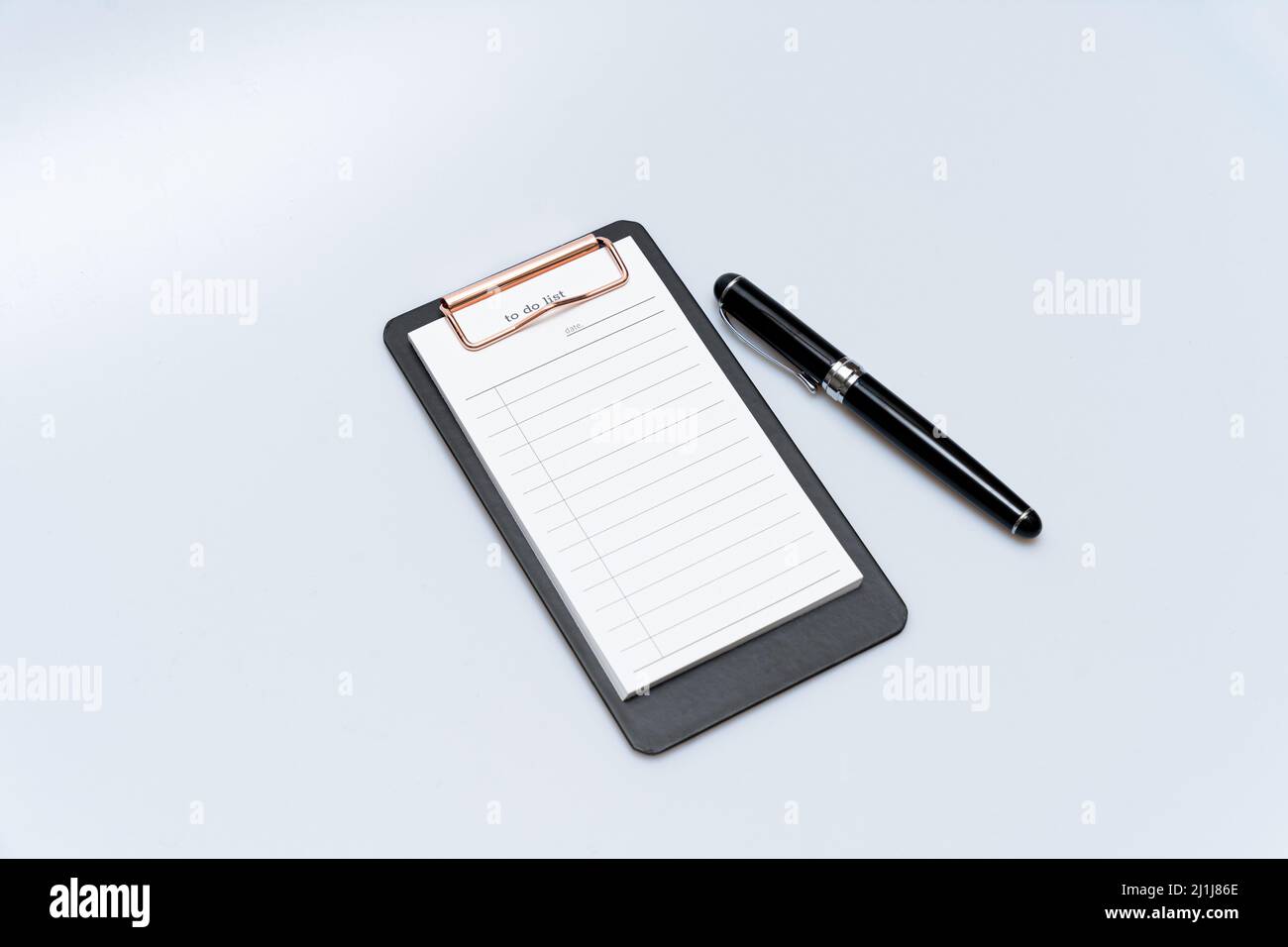 To-do list and fountain pen on a white background Stock Photo - Alamy