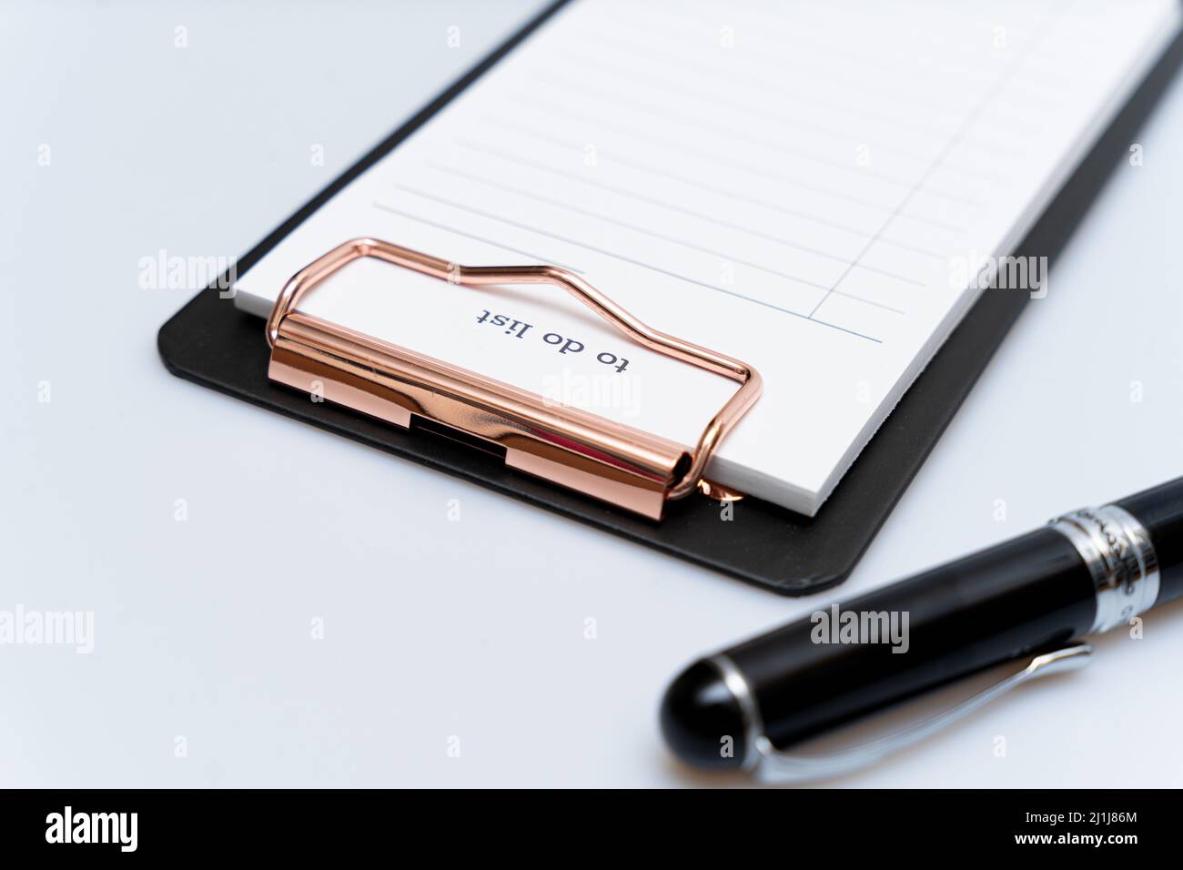 To-do list and fountain pen on a white background Stock Photo - Alamy