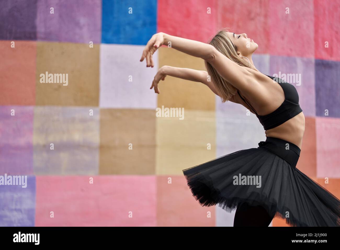 Blonde ballet dancer posing next to colorful wall Stock Photo - Alamy