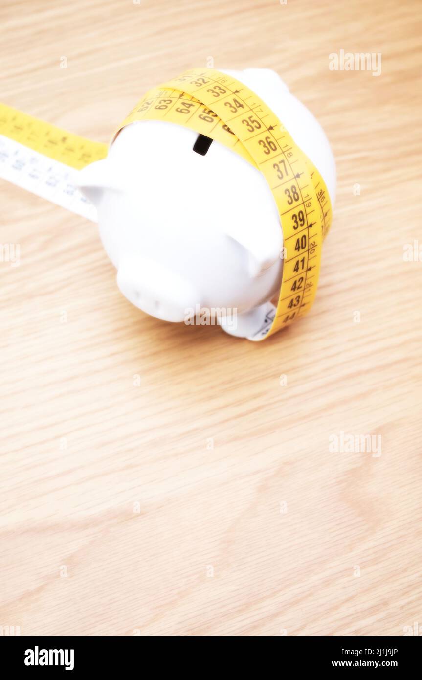 Inflation and devaluation concept - Piggy bank wrapped in a flexible ...