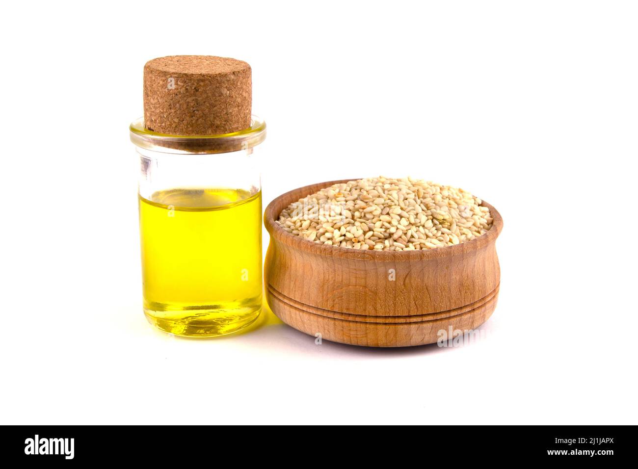 Sesame oil in glass and seeds isolated on white background Stock Photo ...