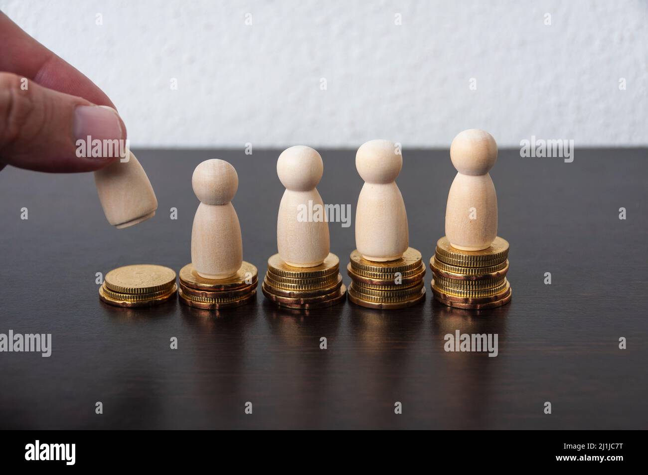 Coins Stack with wooden doll model and finger background - Business ...
