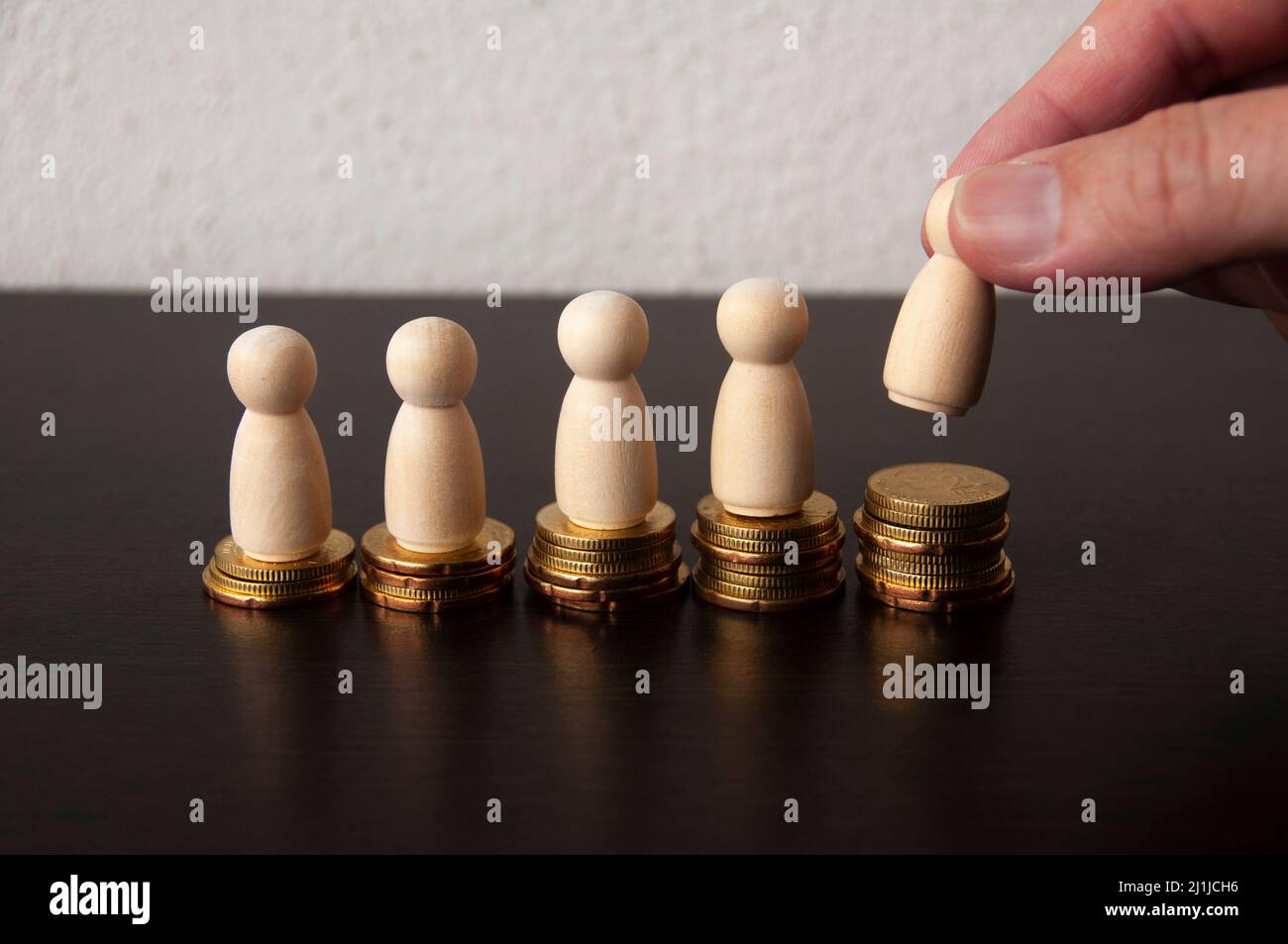 Coins Stack with wooden doll model and finger background - Business and ...