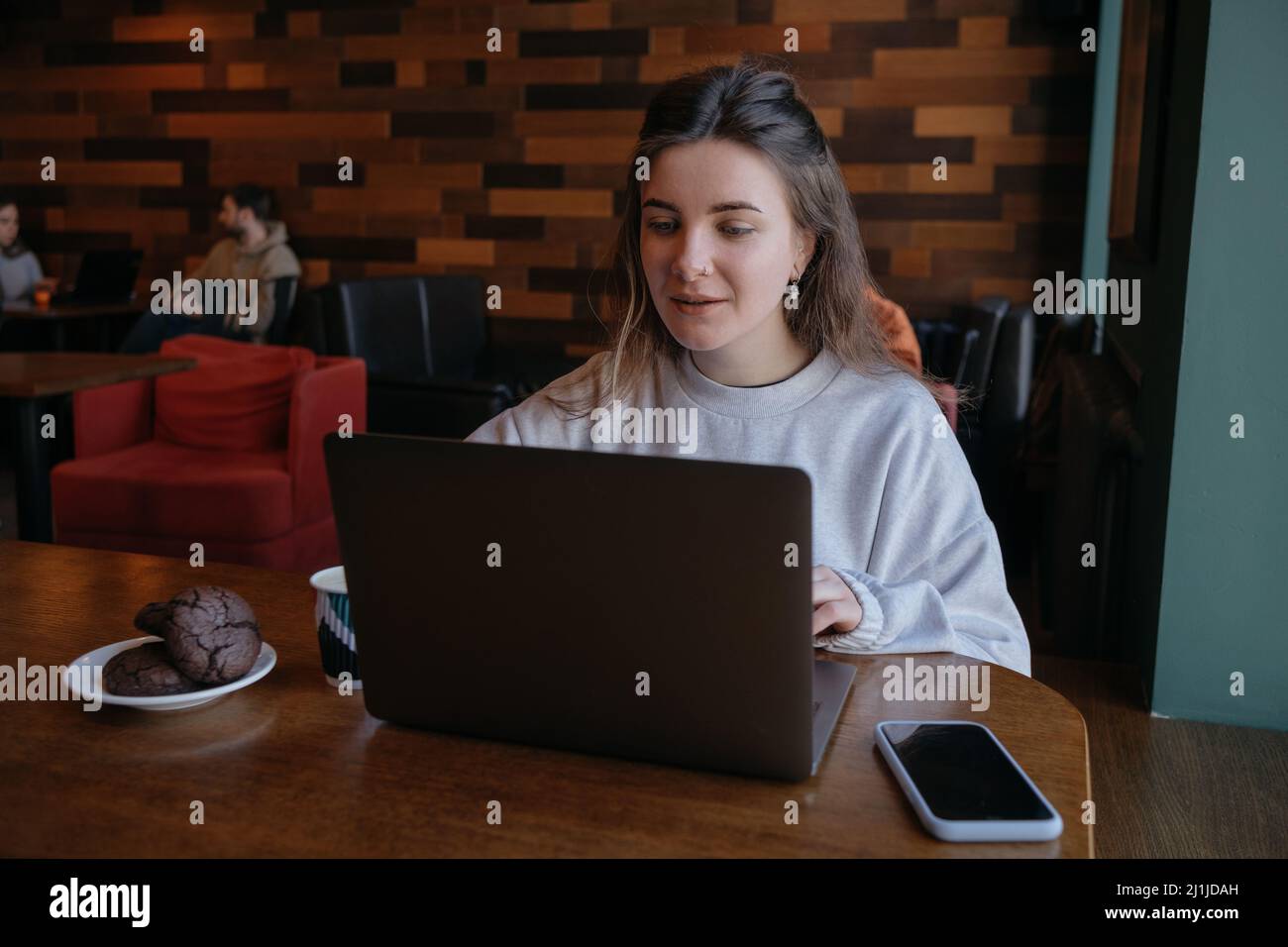 freelance woman happy working in a cafe remotely Stock Photo - Alamy