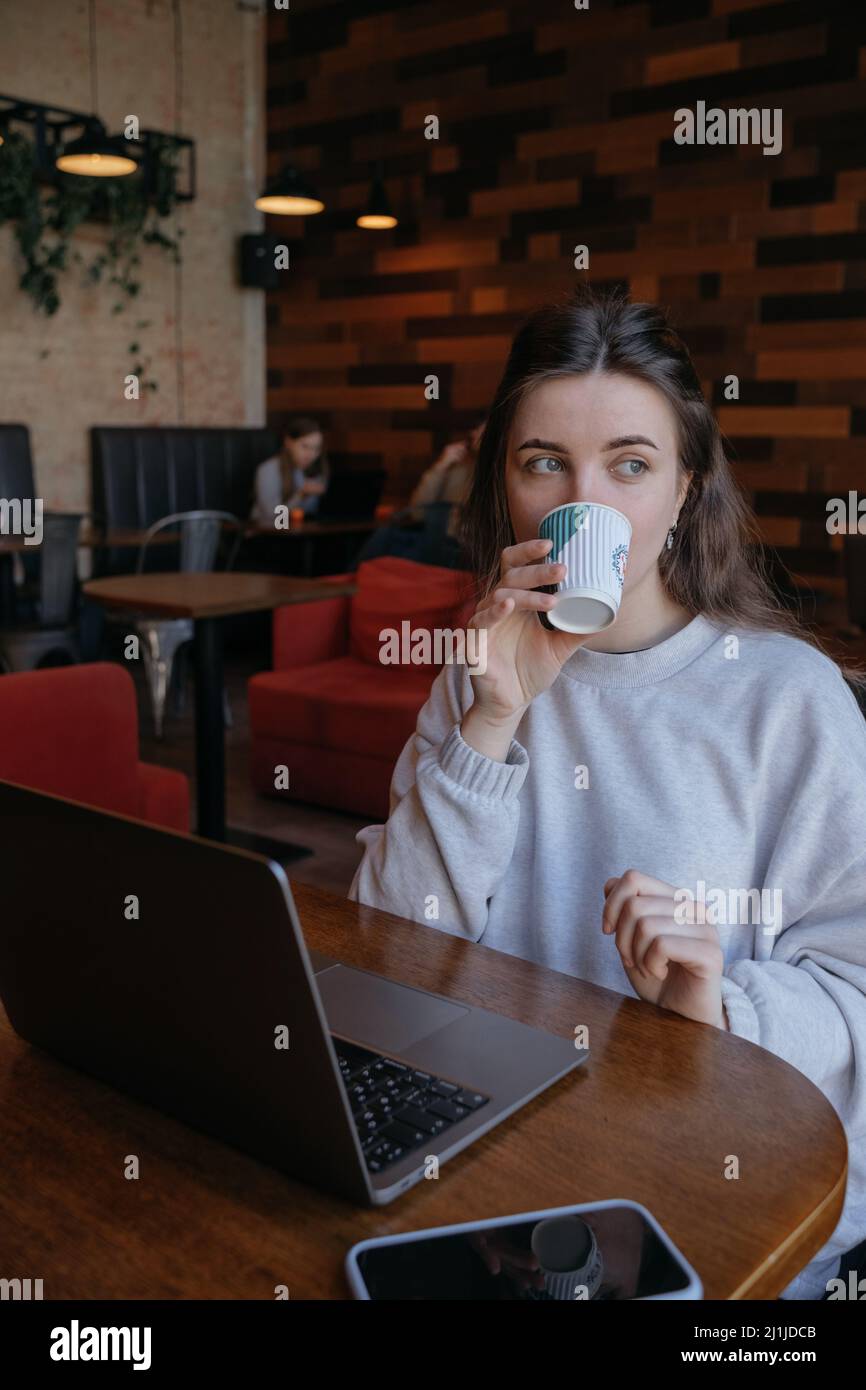 freelance woman happy working in a cafe remotely Stock Photo - Alamy