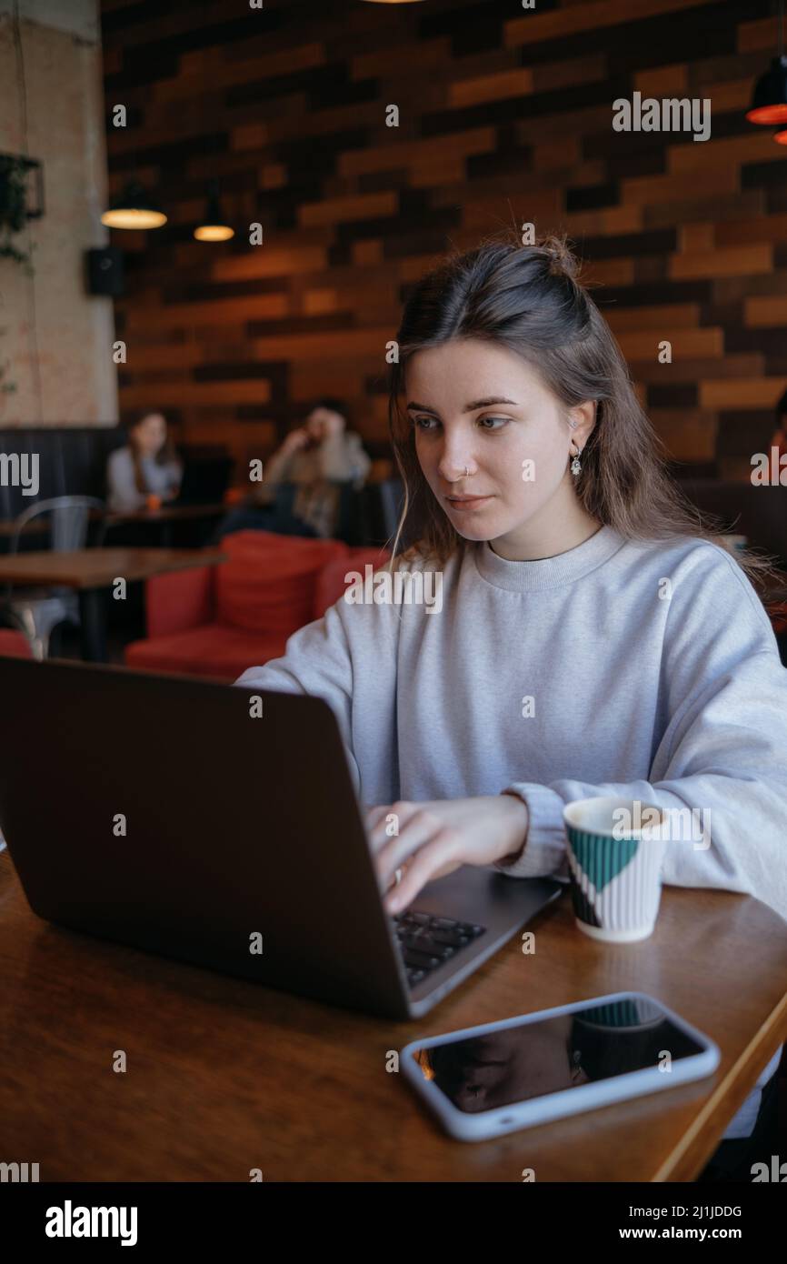freelance woman happy working in a cafe remotely Stock Photo - Alamy