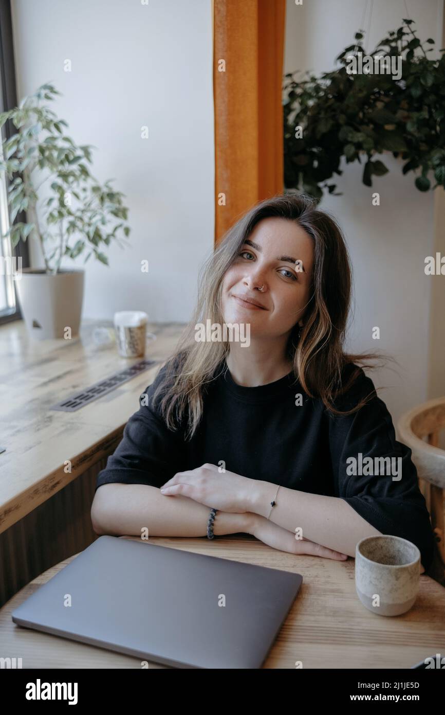 freelance woman happy working in a cafe remotely Stock Photo - Alamy