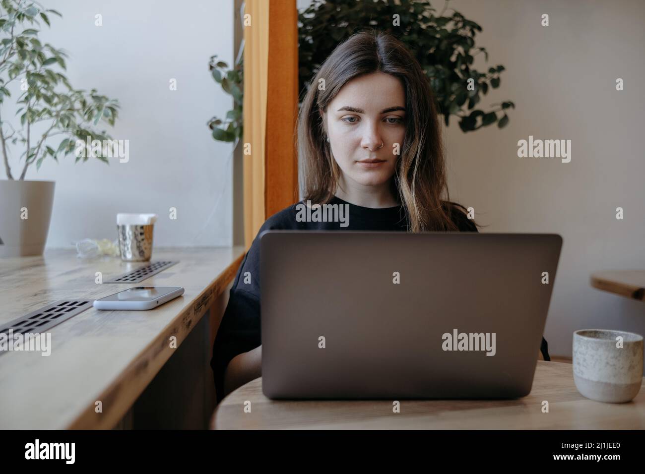 freelance woman happy working in a cafe remotely Stock Photo - Alamy