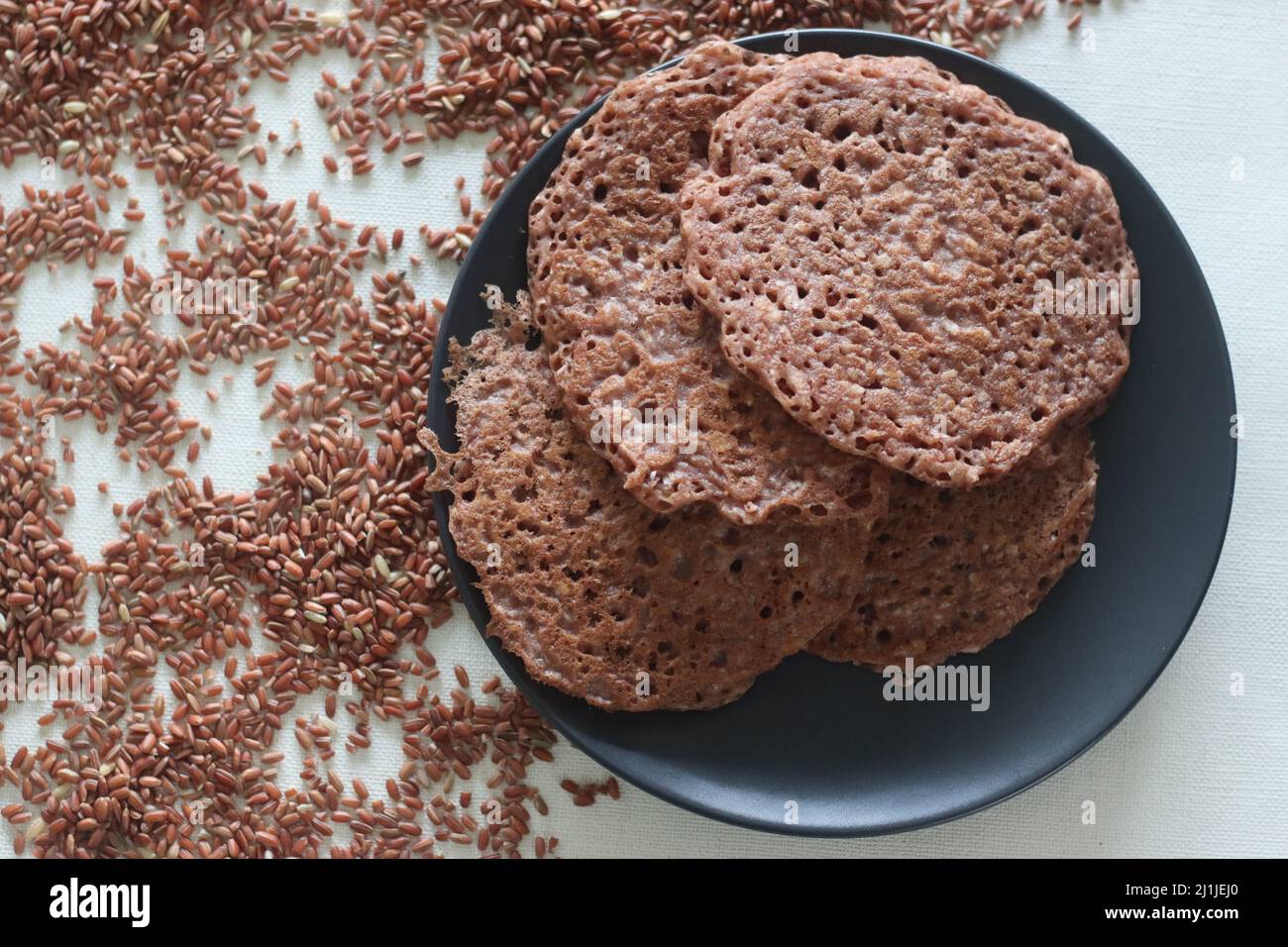 Red rice pancakes. Pancakes made of a fermented batter of red rice and ...