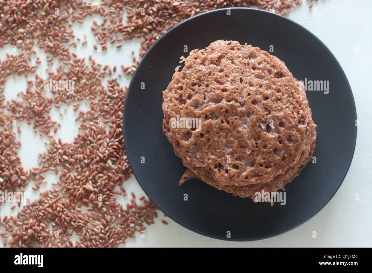 Red rice pancakes. Pancakes made of a fermented batter of red rice and ...