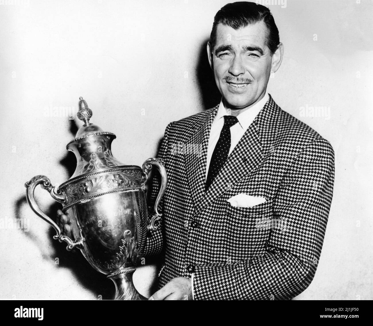 CLARK GABLE displays Trophy presented by REDBOOK magazine in their 10th ...