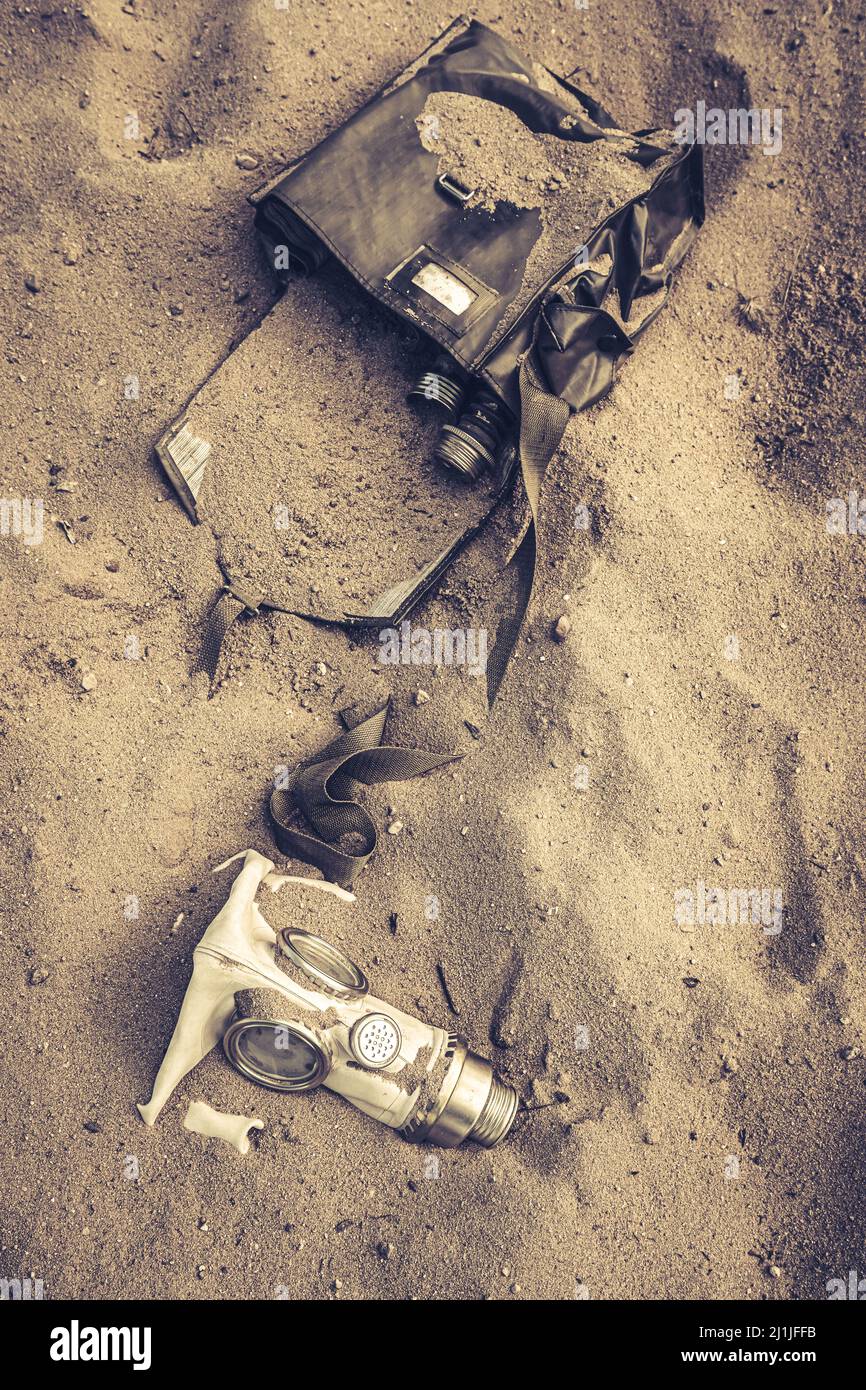 Damaged gas mask in the sunburned desert. Destroyed gas mask in a ...