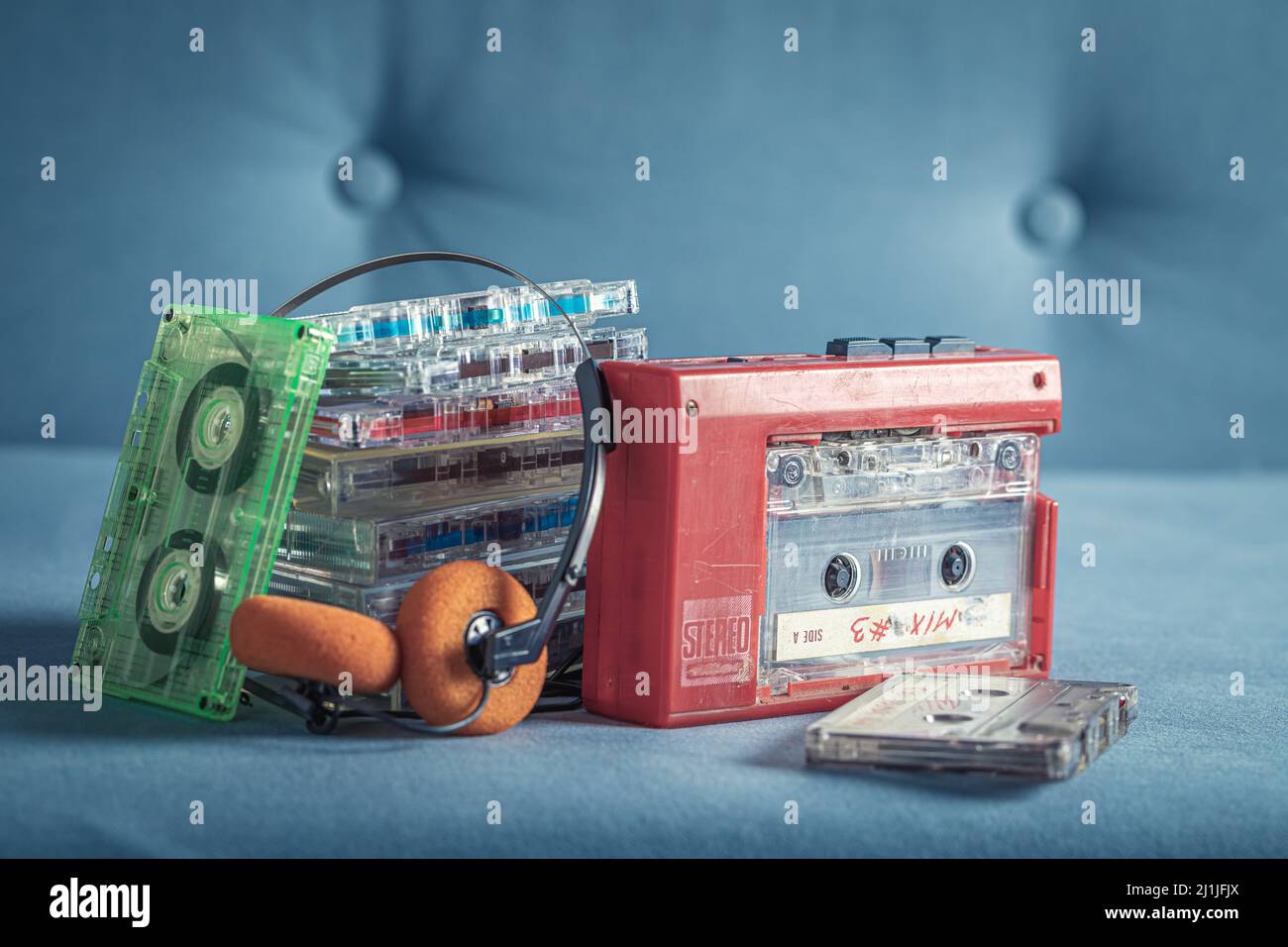 Transparent audio cassette with orange headphones and player. Cassette ...