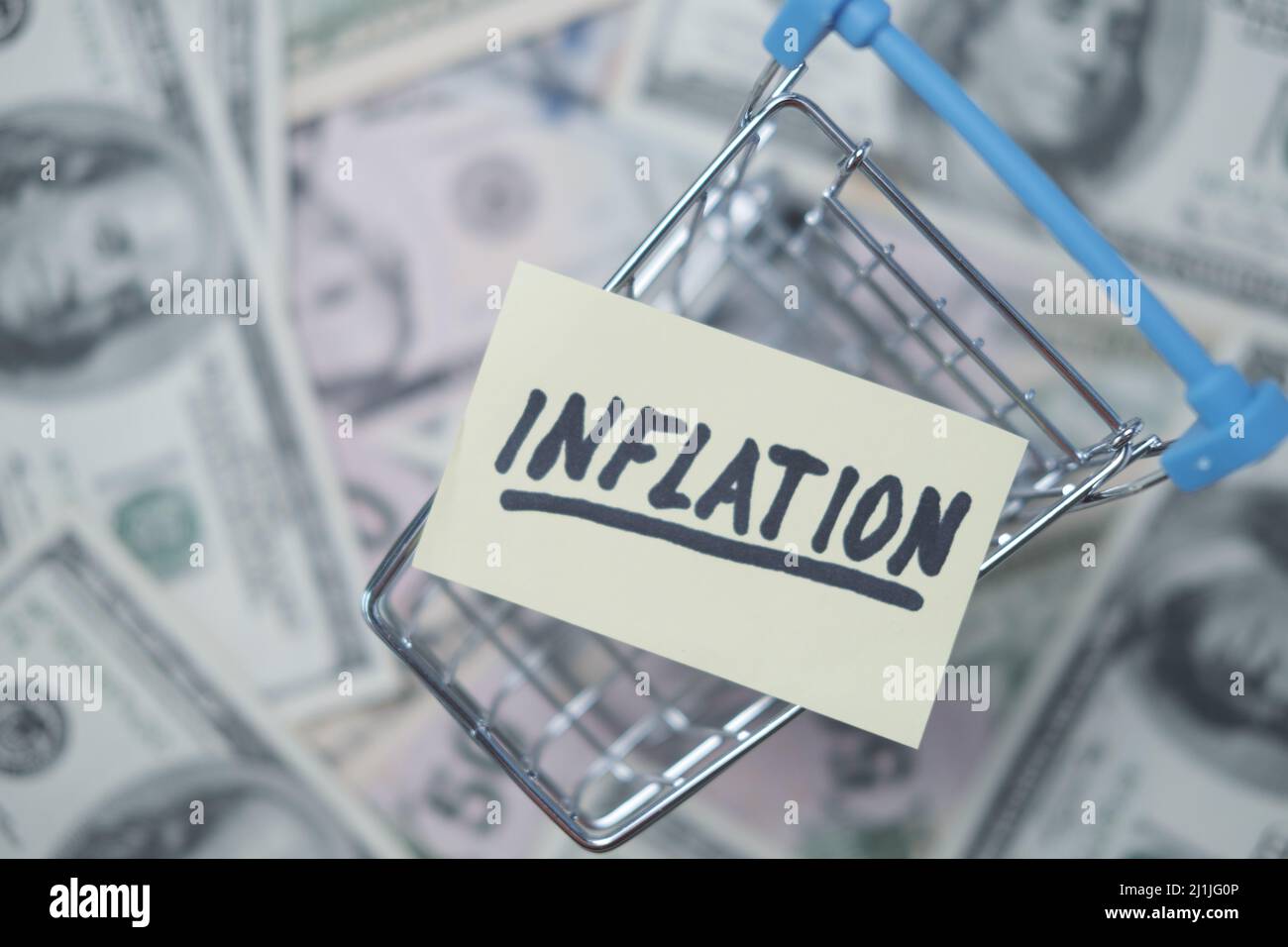 Shopping cart with inflation poster on a blurred background made of ...