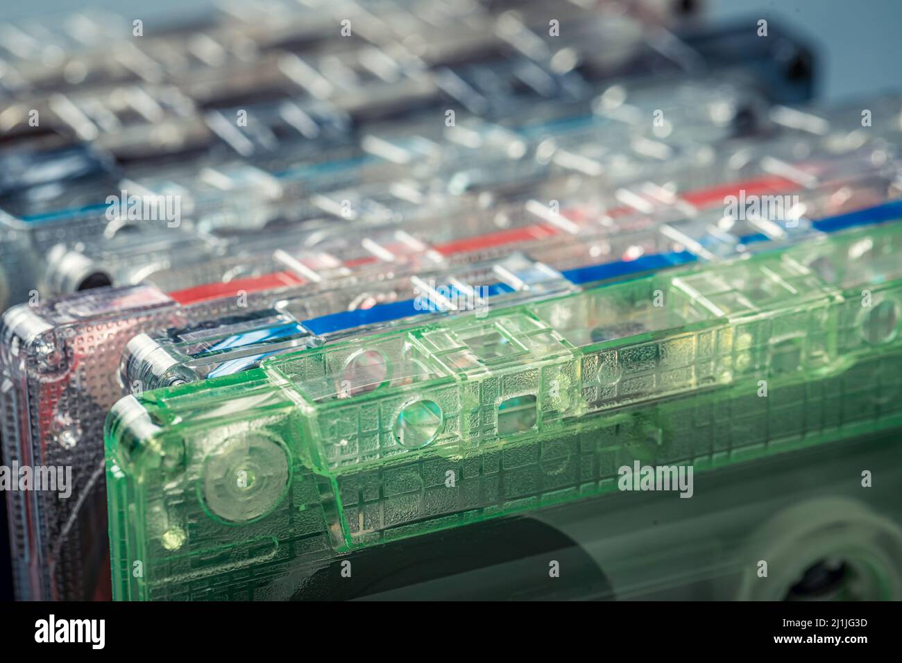 Closeup of pile of transparent full audio cassettes on blue sofa Stock ...