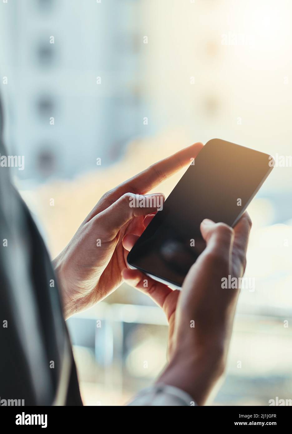 Staying in touch. Shot of an unrecognizable young businesswoman using ...