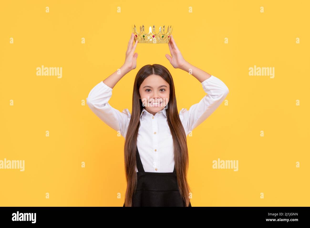 happy selfish teen girl in school uniform wear princess crown ...