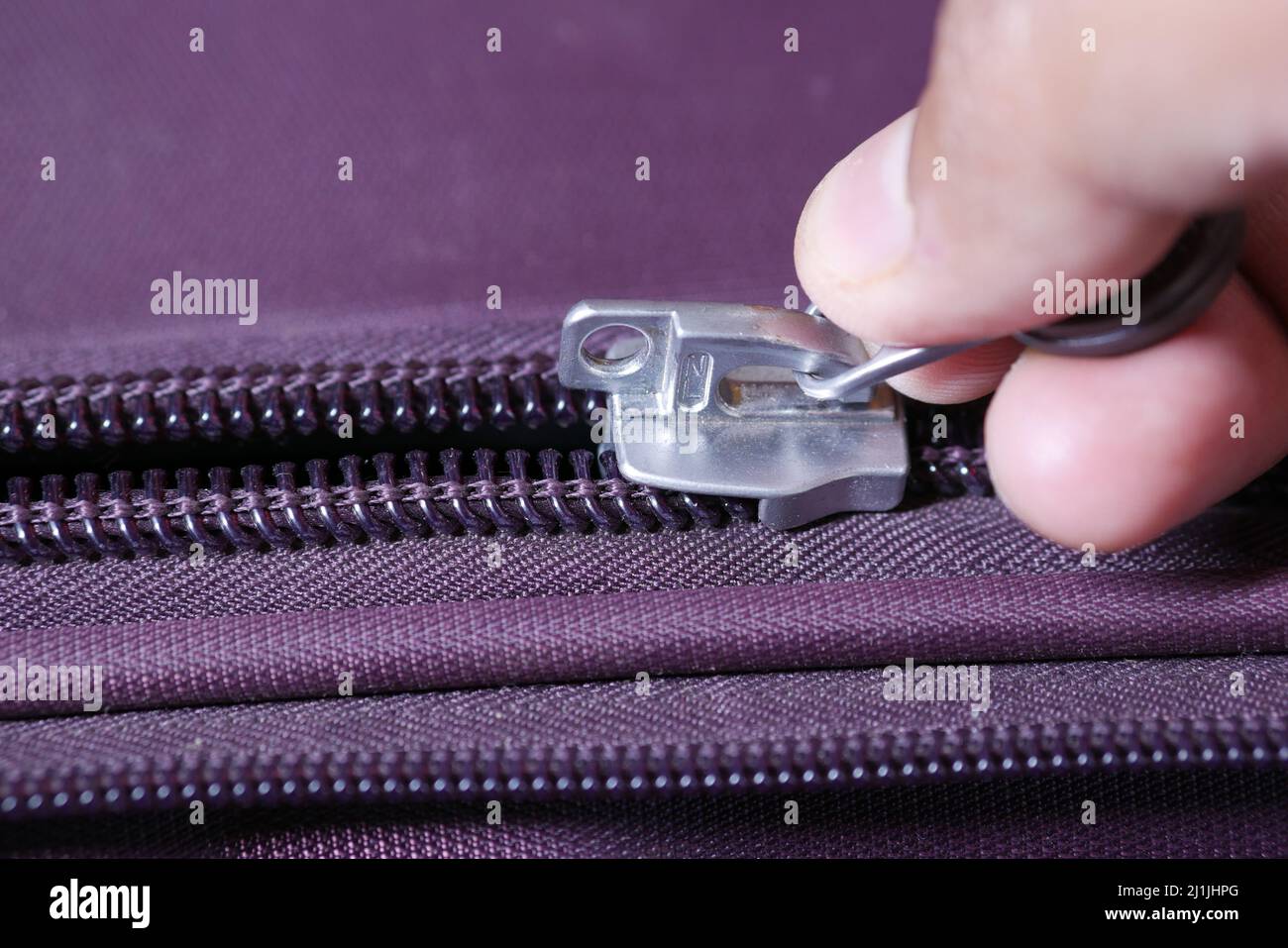 hand in a Zipper on a suitcase Stock Photo - Alamy