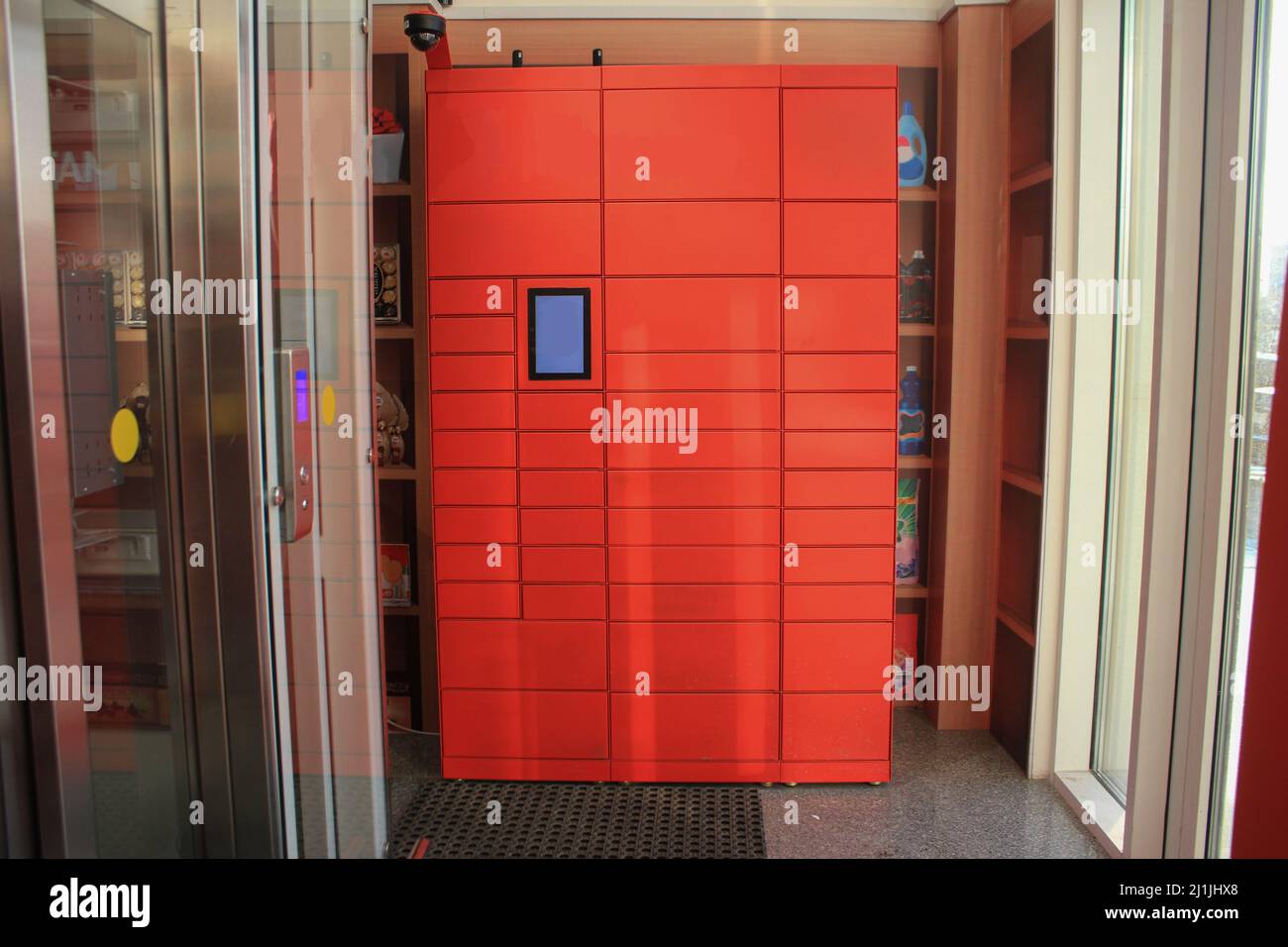 a bright red delivery locker in a grocery store Stock Photo - Alamy