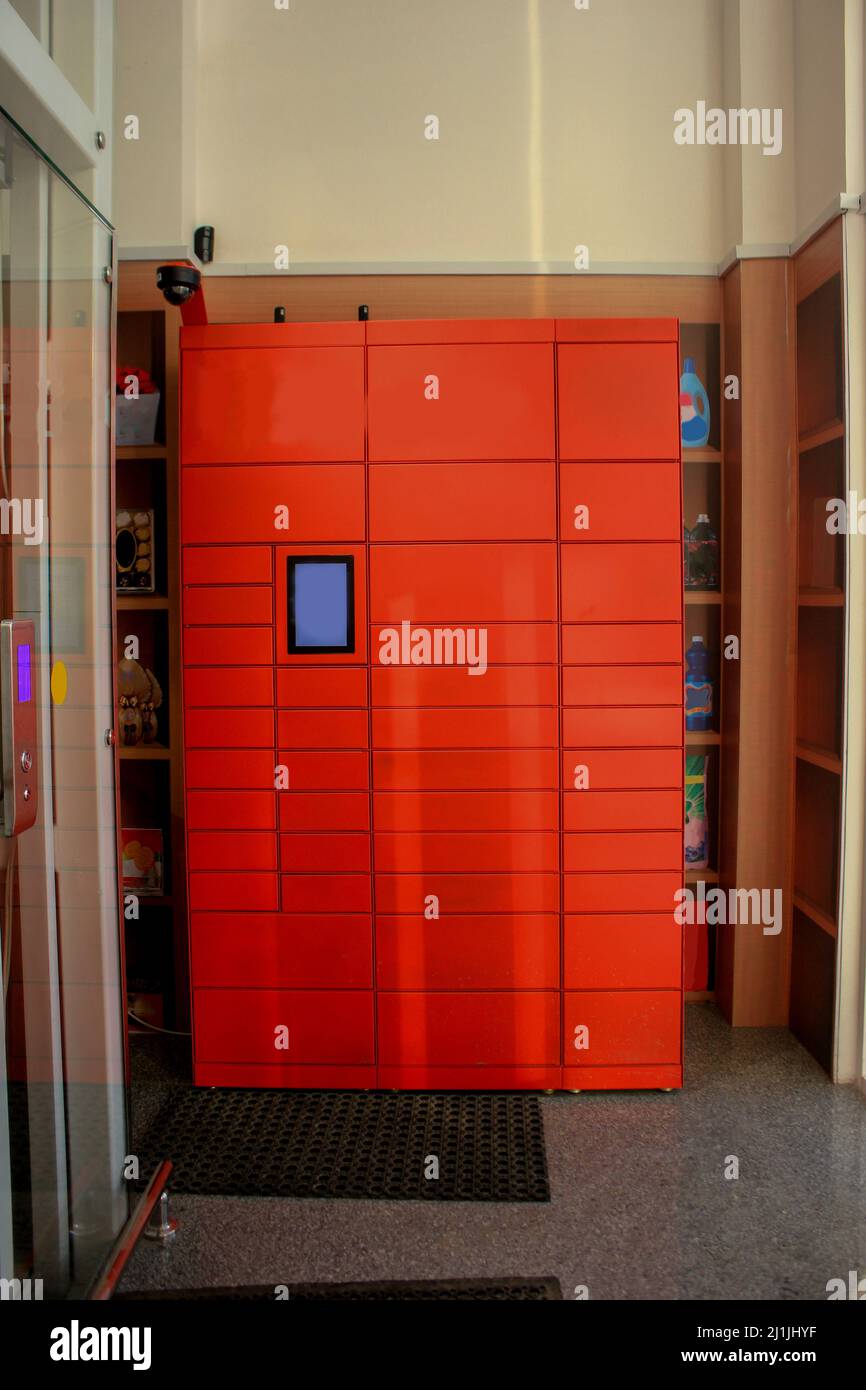 a bright red delivery locker in a grocery store Stock Photo - Alamy