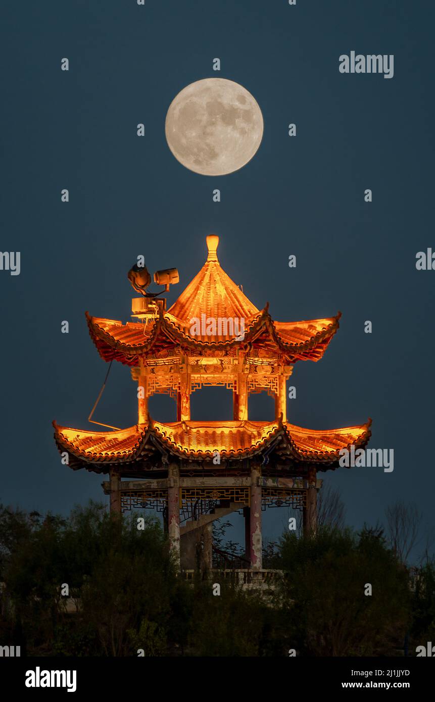 The golden Asian pagoda against the background of the full moon Stock ...