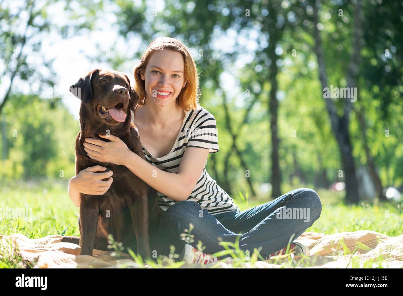 Young attractive woman hugs her dog in the park Stock Photo - Alamy