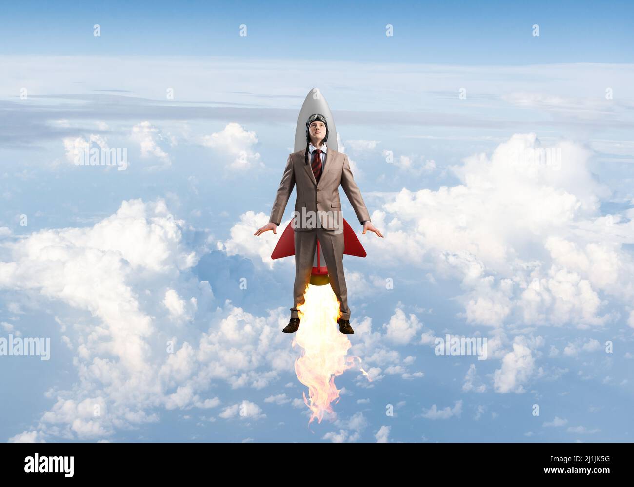 Business person in aviator hat flying on rocket Stock Photo - Alamy