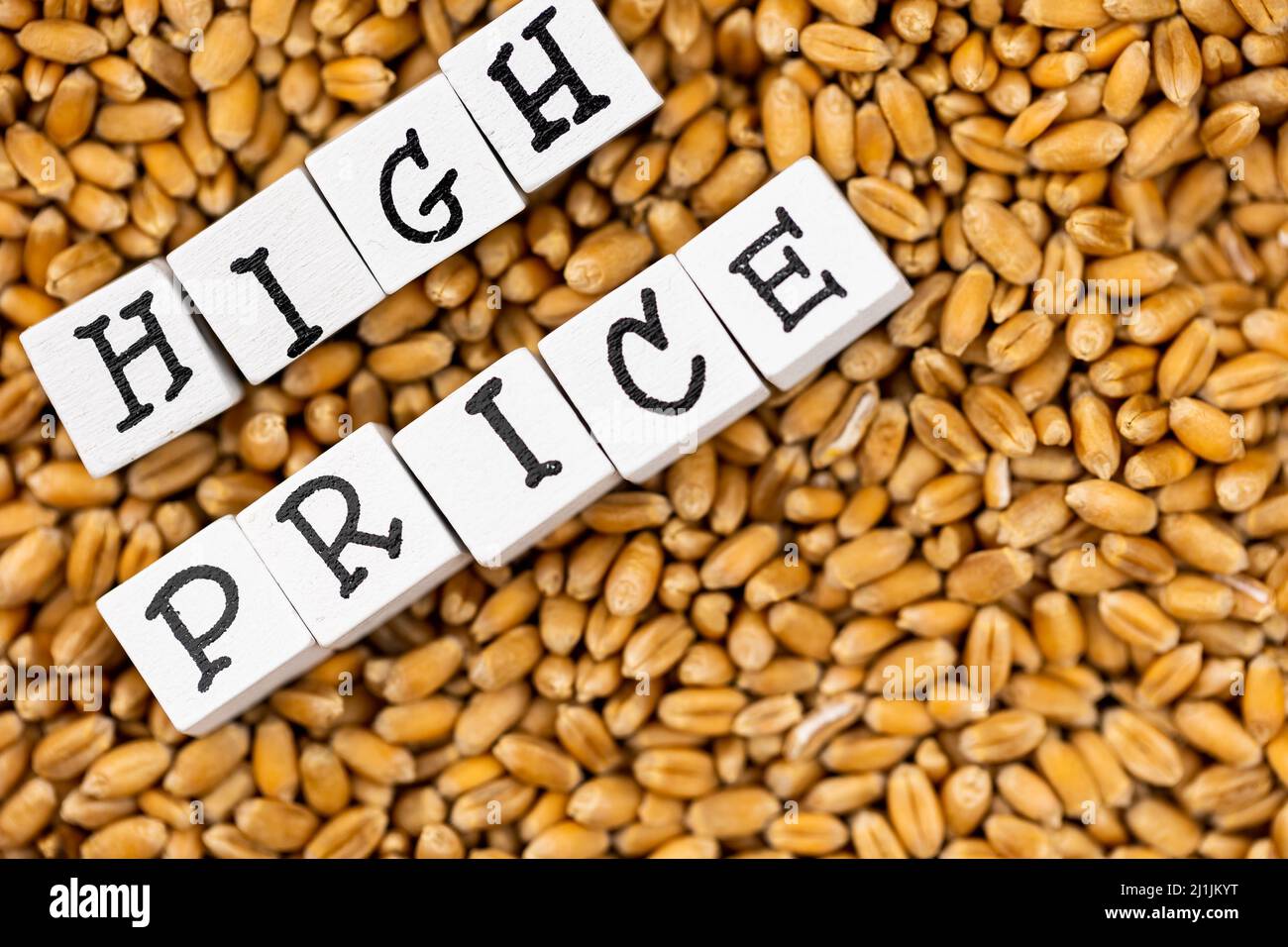 The wording "High Price" composed on the background of bulk wheat grain ...