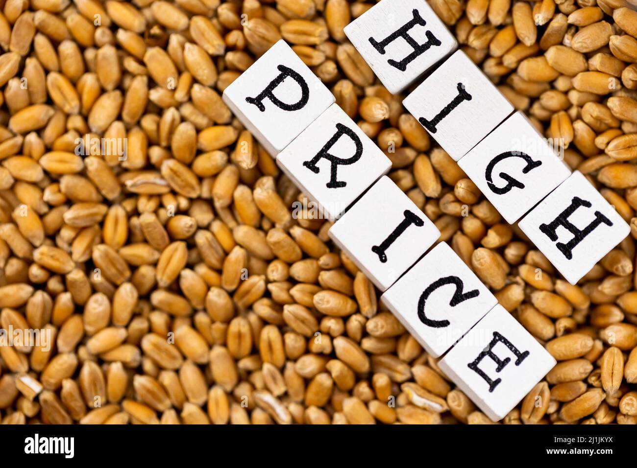 The wording "High Price" composed on the background of bulk wheat grain ...
