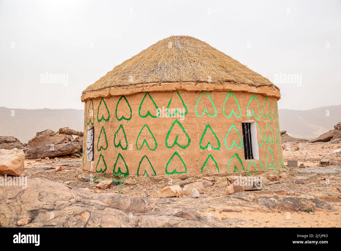 Traditional thatched building decorated with green hearts, Toungat ...