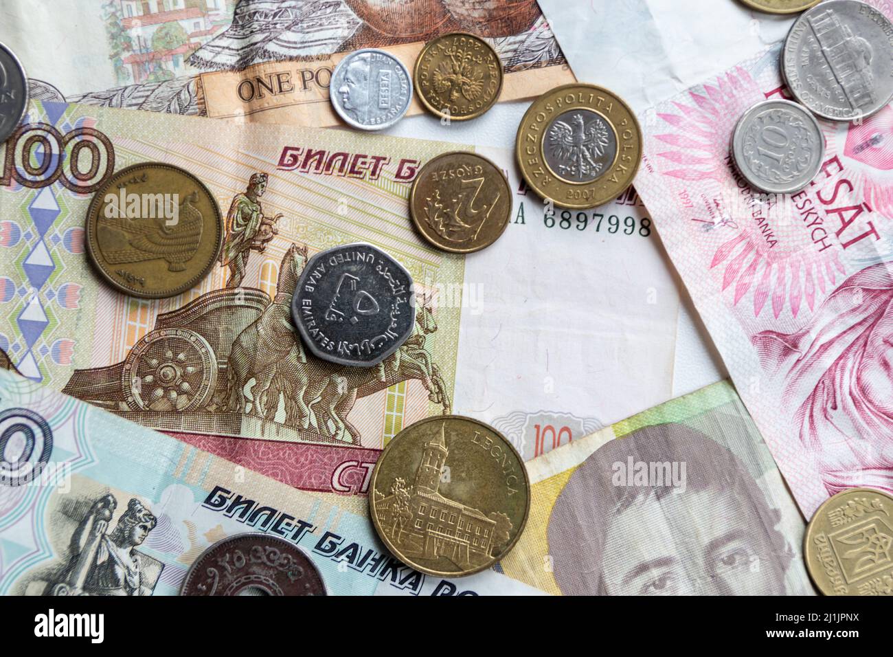 Variety of different bank notes and coins from various countries like ...