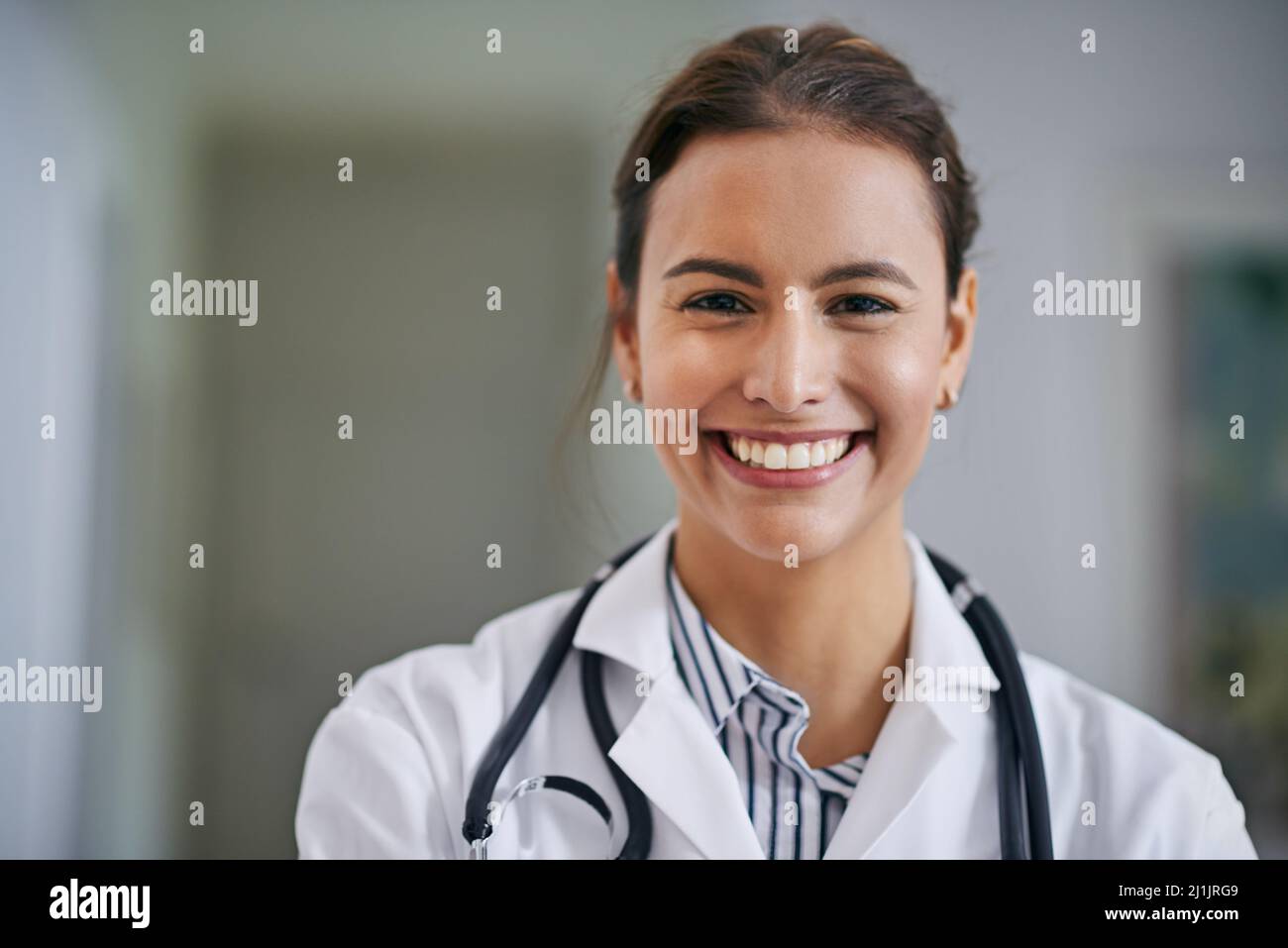 The smile that puts every patient at ease. Portrait of a cheerful young ...