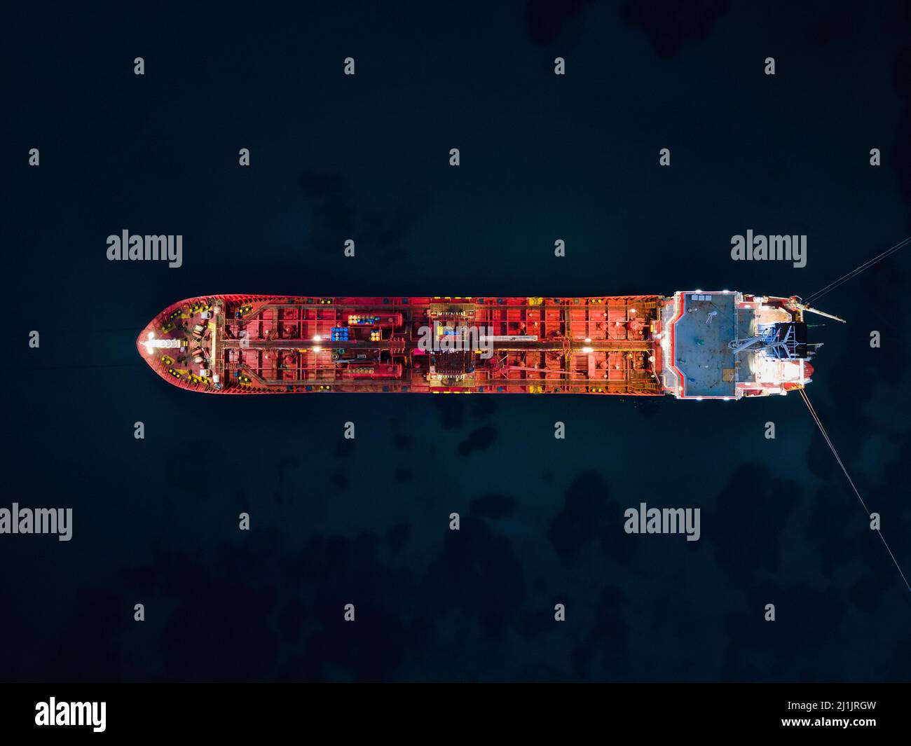 Aerial top view by drone of a cargo ship at open sea close to harbour ...