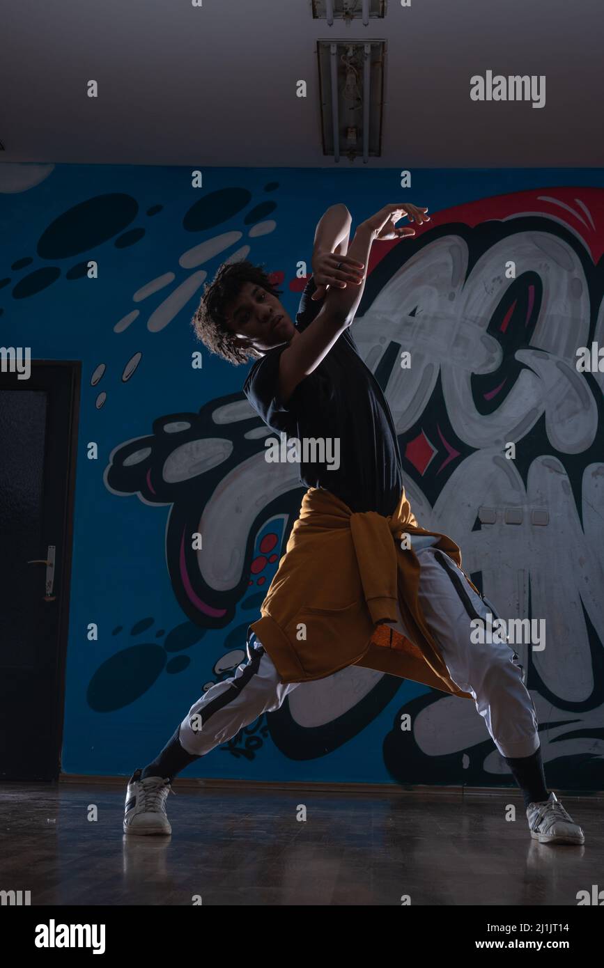 Young black male dancing hip hop style in an urban setting. he is ...