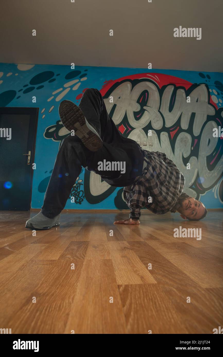 Trendy young man dancer dancing in front of graffiti Stock Photo - Alamy