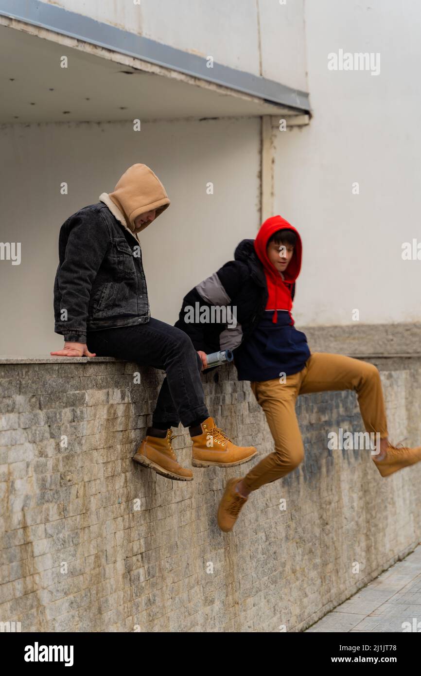 Two handsome young male friends are getting down Stock Photo - Alamy