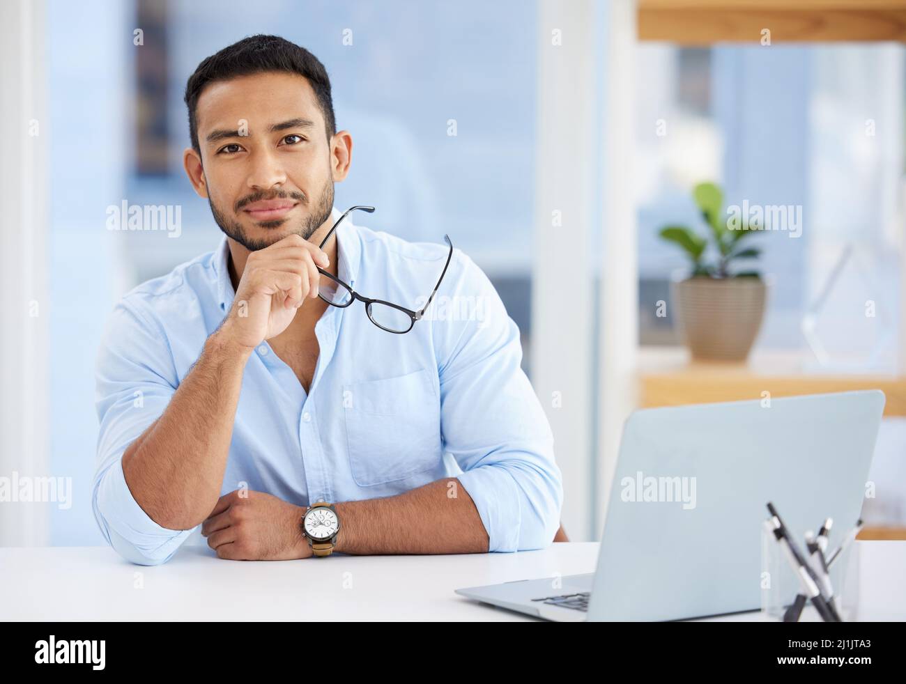 I can bring your idea to life. Shot of a young man using a laptop at ...
