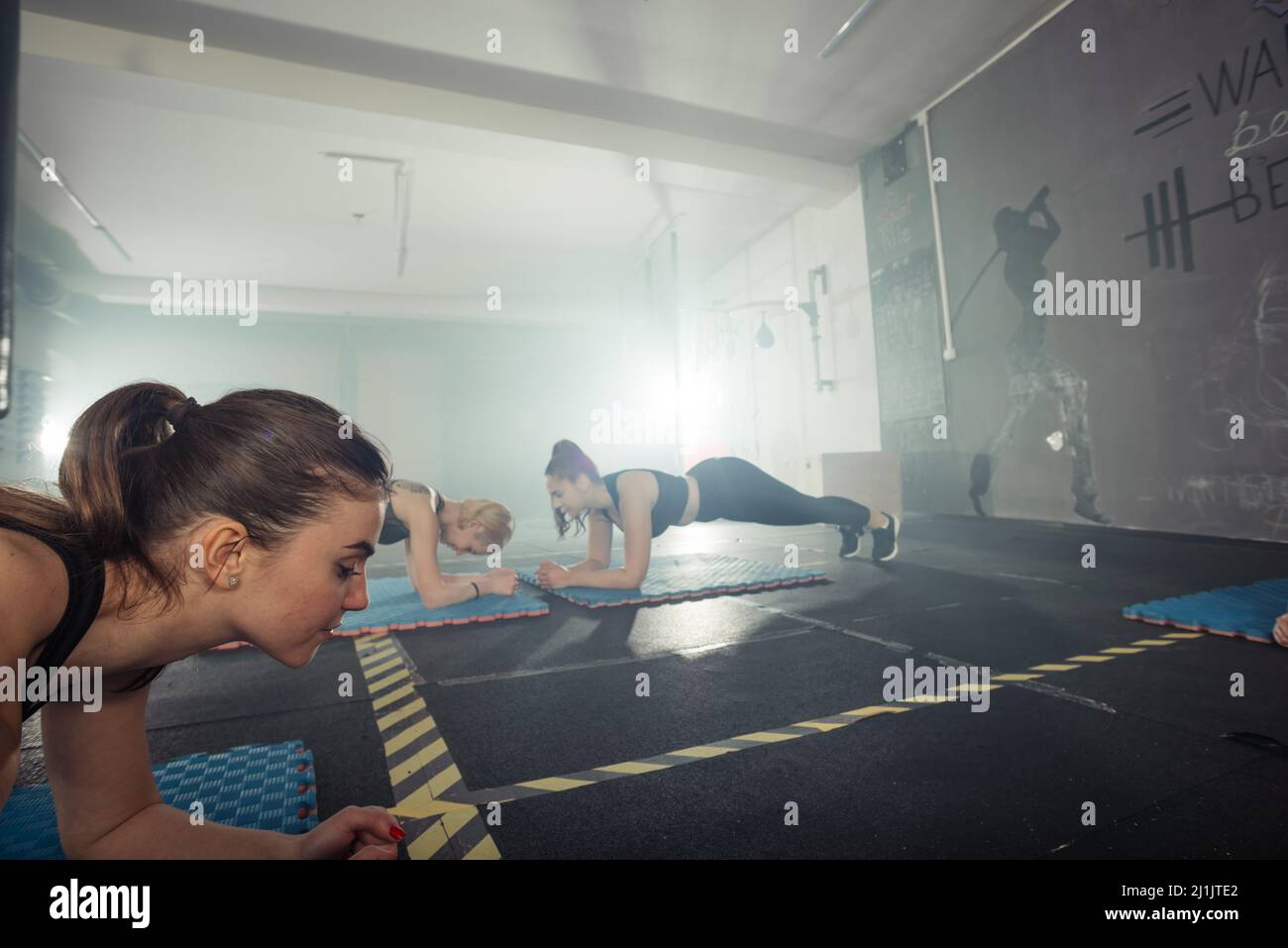 Women in black and white sportswear on a real group body Combat workout ...