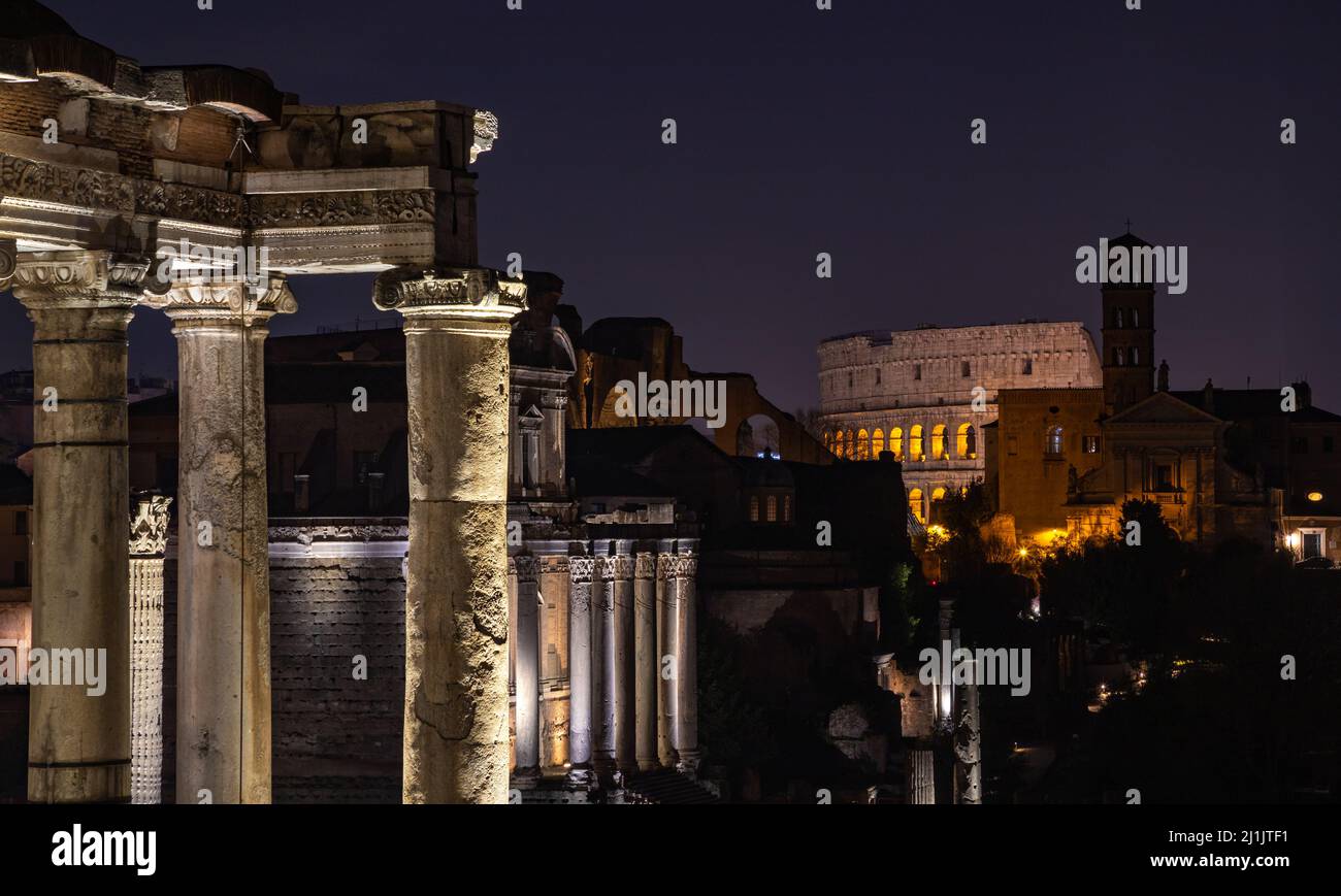 A picture of the Temple of Saturn and the Colosseum at night Stock ...