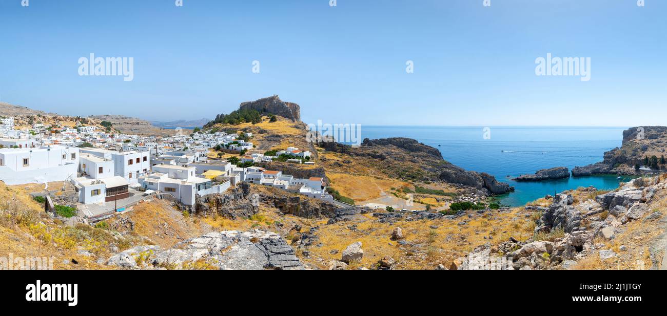 Lindos, with its ancient acropolis, ruins fortress and closed bays in ...