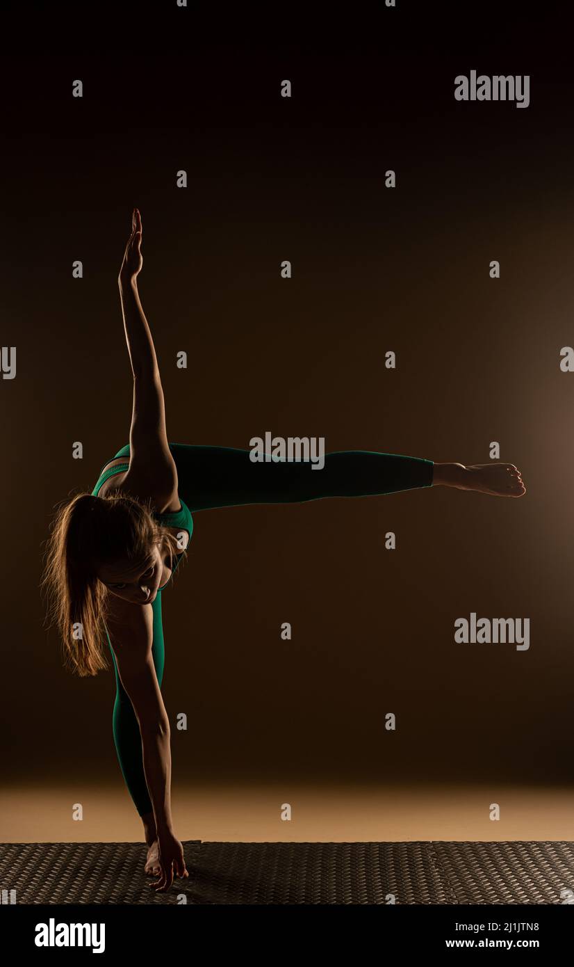 Attractive and beautiful young girl is trying to balance the pose Stock ...