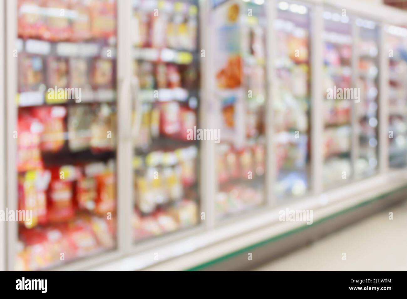 Frozen food section in supermarket blurred background Stock Photo - Alamy
