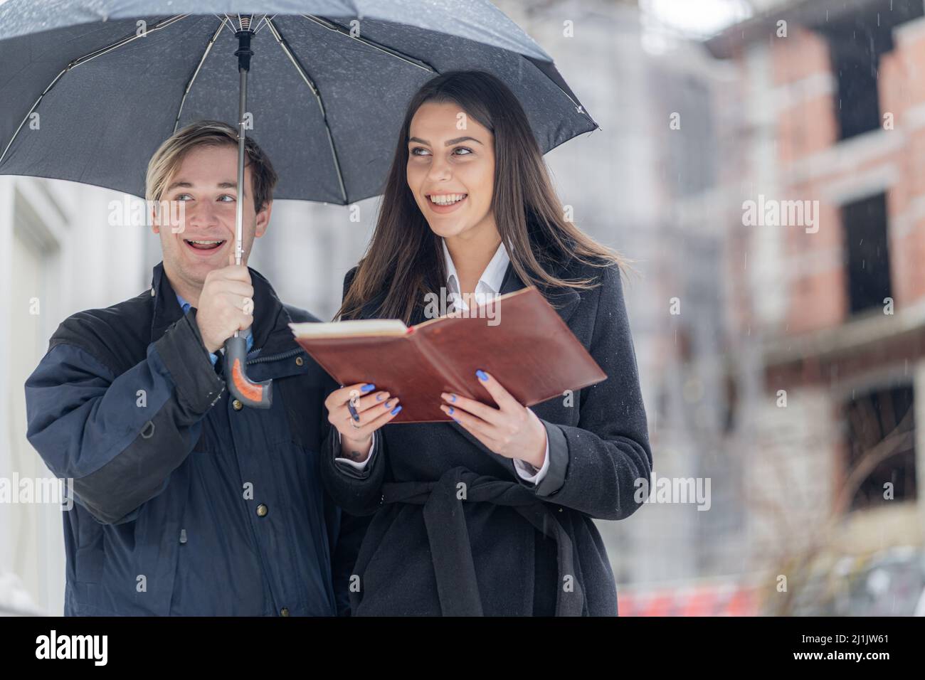 Two young and amazing business people are having a discussion and ...