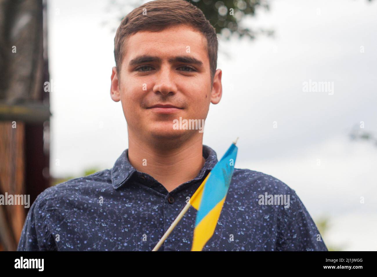 Ukrainian man. Young man holding ukrainian flag. No war. Support for ...
