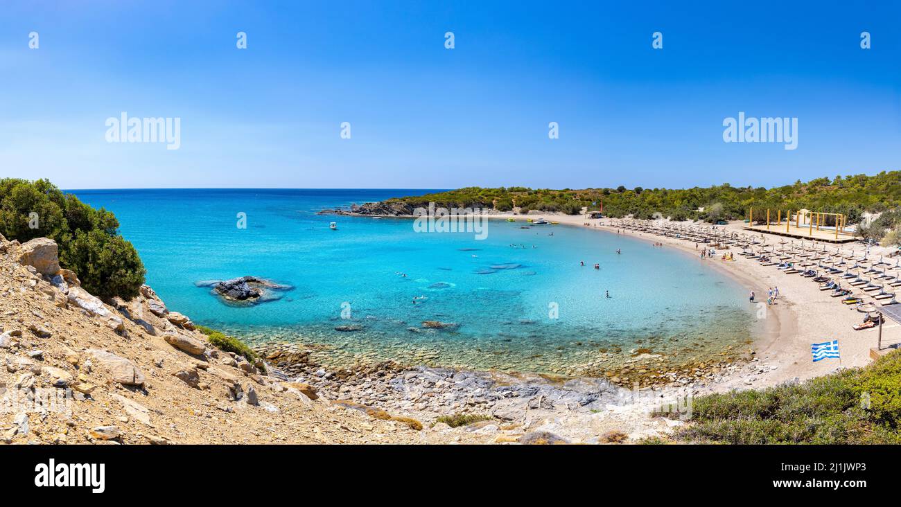 Crystal clear turquoise water in a Glystra beach. Cane umbrellas and ...